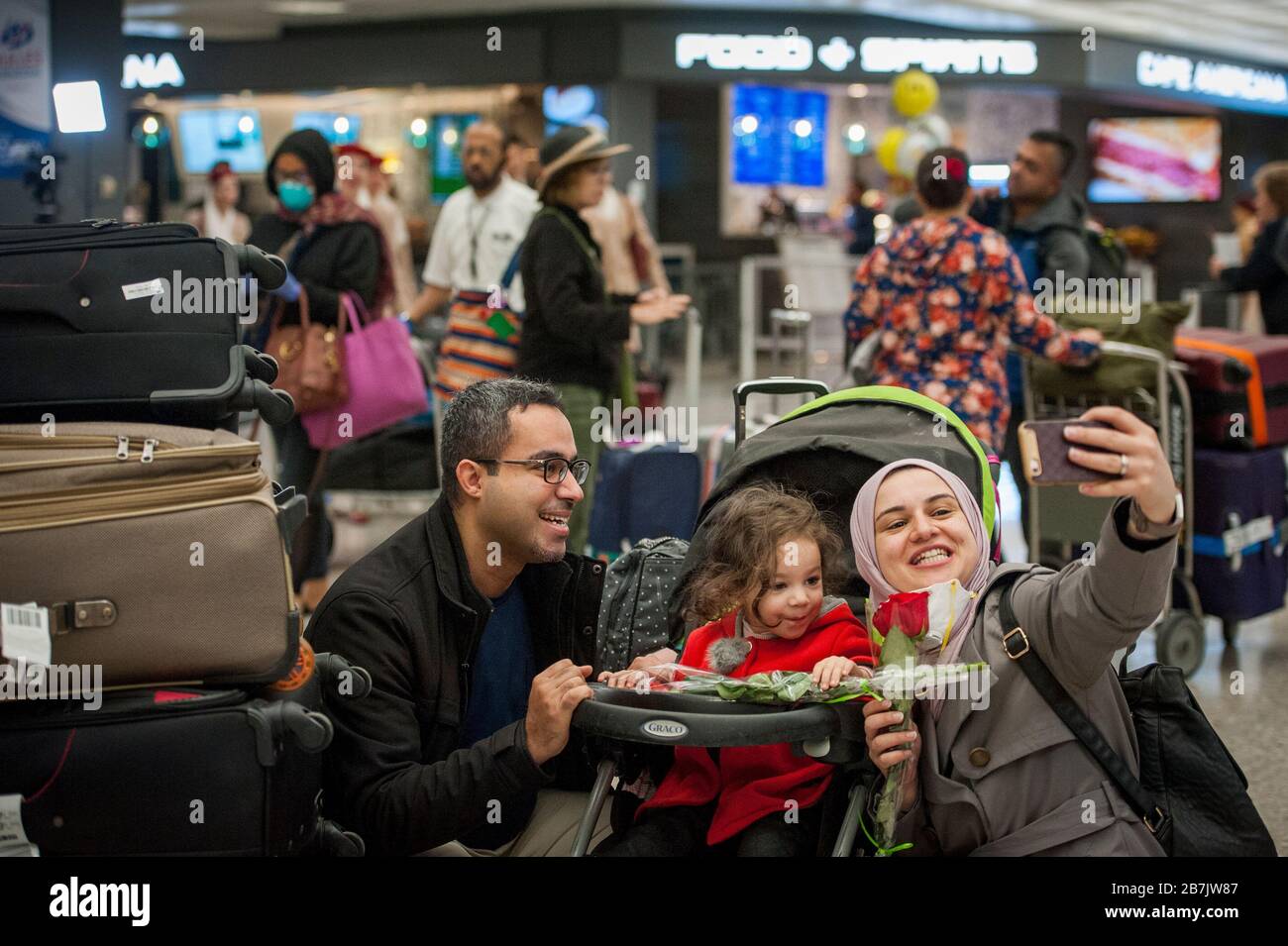 A family is united and takes a selfie, as passengers arrive from Dubai ...