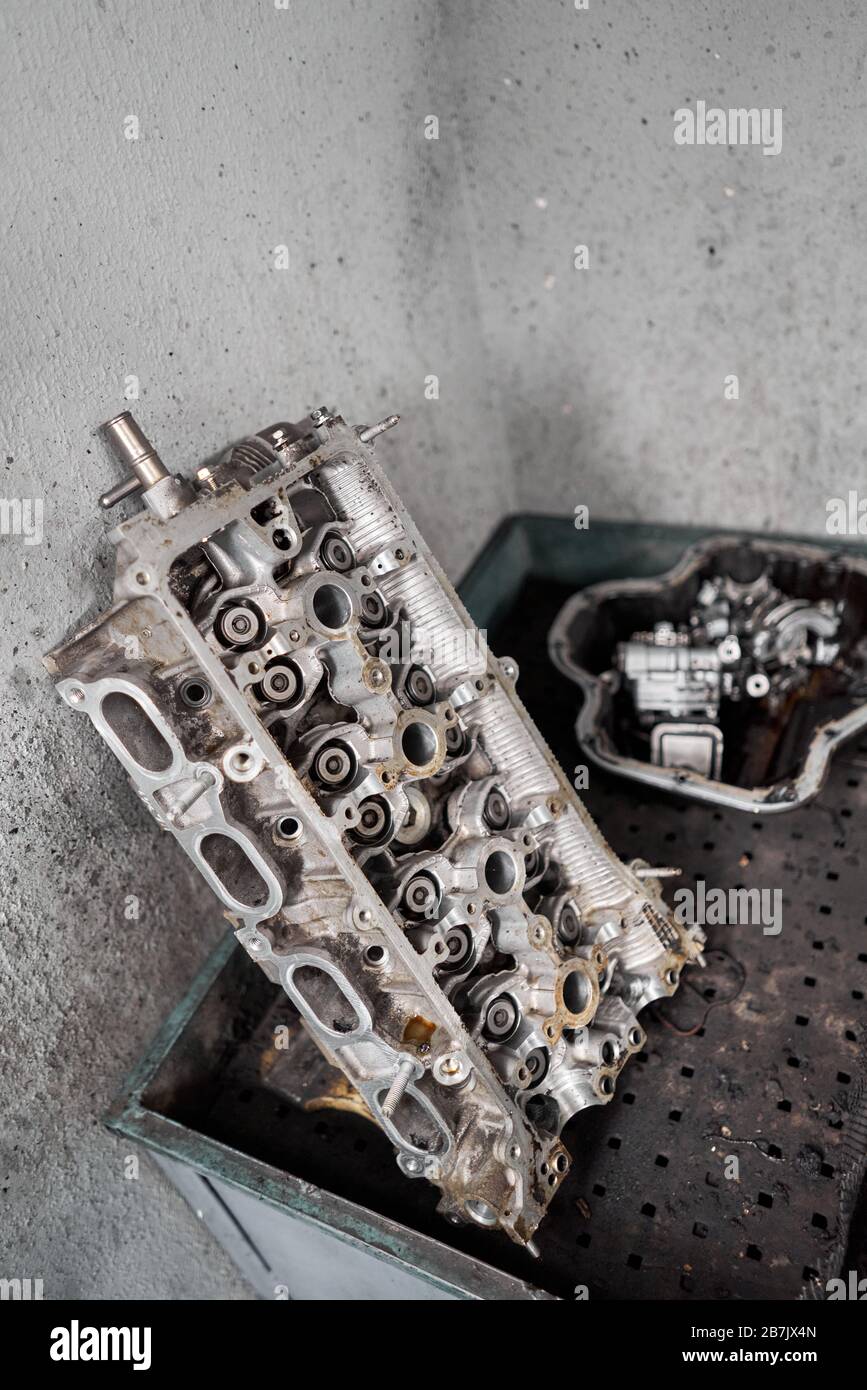 Disassembled engine block is on the table. the mechanic opened the ...