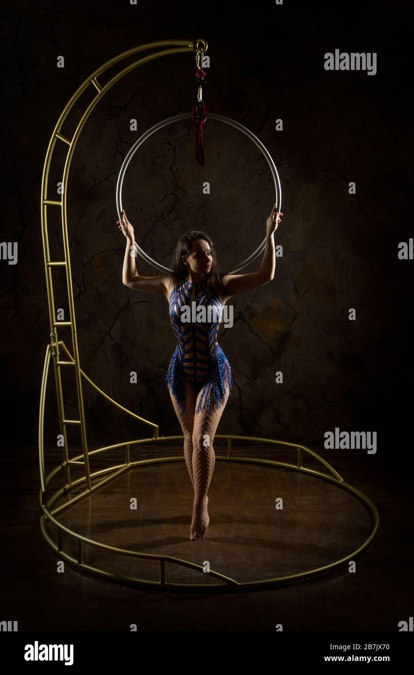 Gorgeous woman, aerial acrobatics, stage in blue dress takes the ...