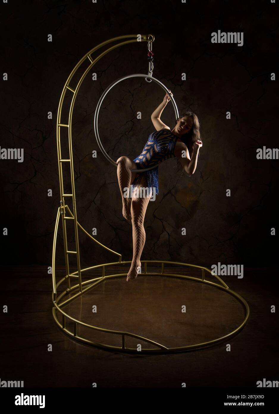 Gorgeous woman, aerial acrobatics, stage in blue dress takes the ...
