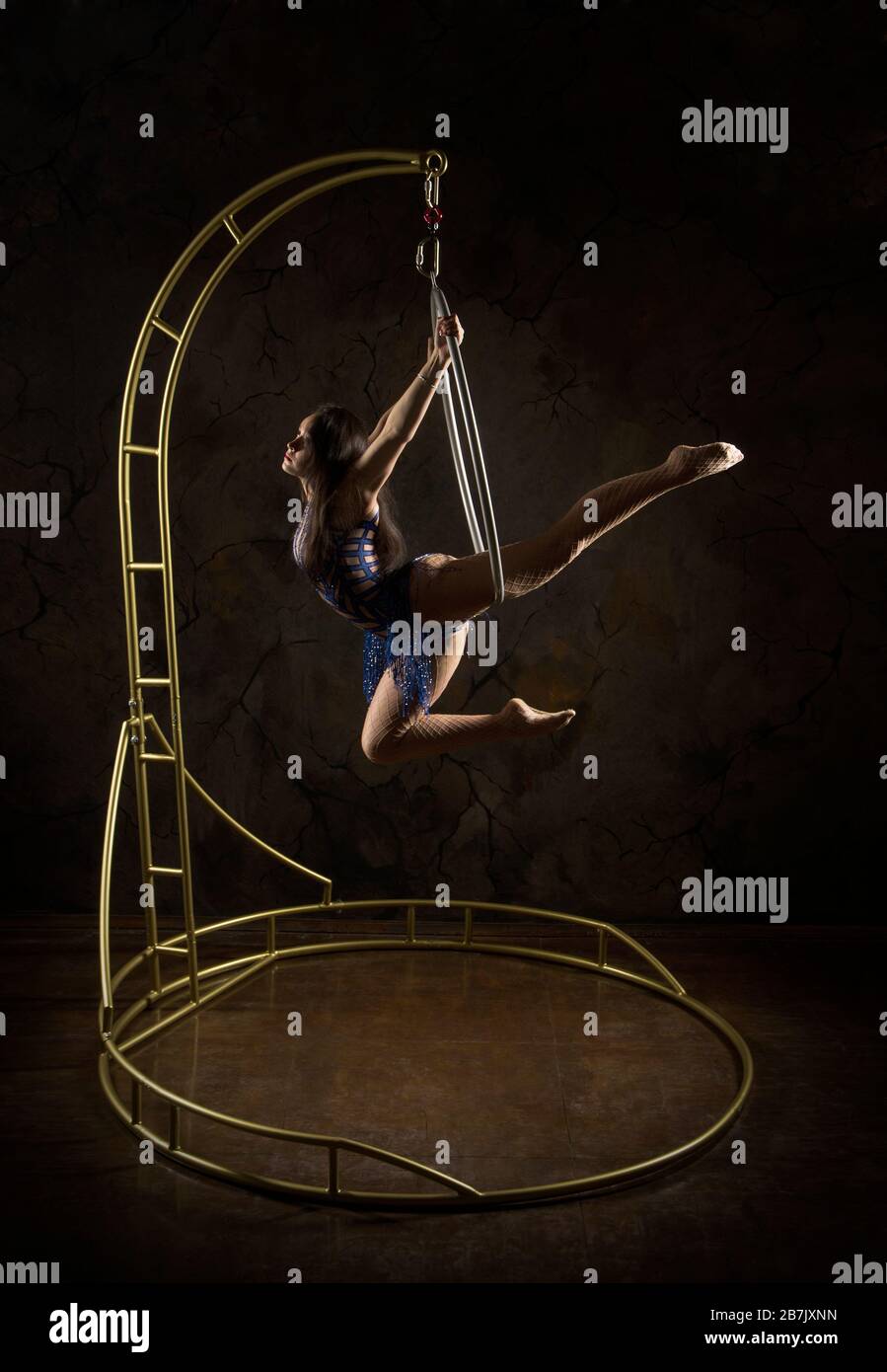 Gorgeous woman, aerial acrobatics, stage in blue dress takes the ...