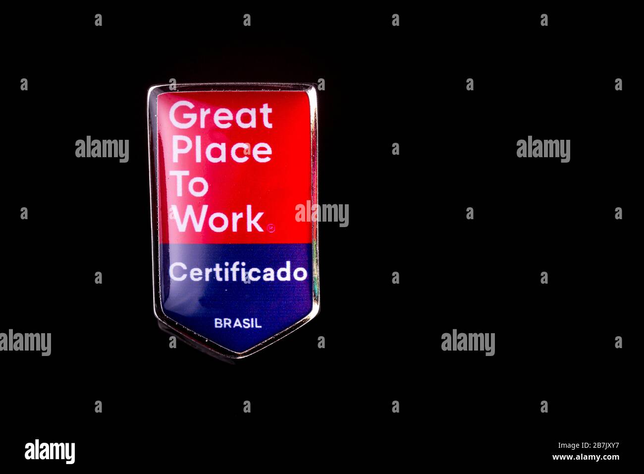 Great place to work button pin on a black surface background ...