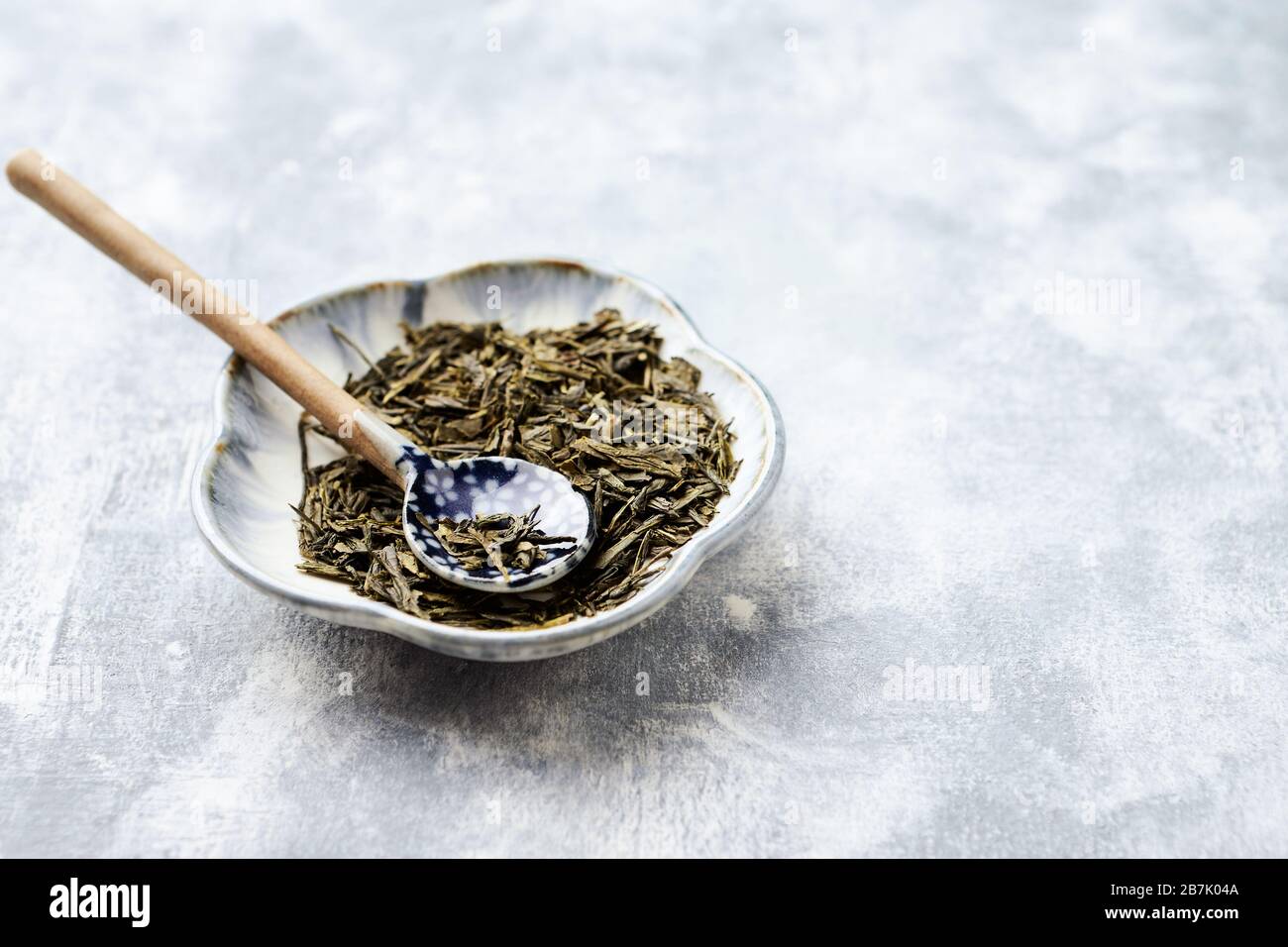Dried Green Tea Leaves on Bright Background. Close up Stock Photo - Alamy