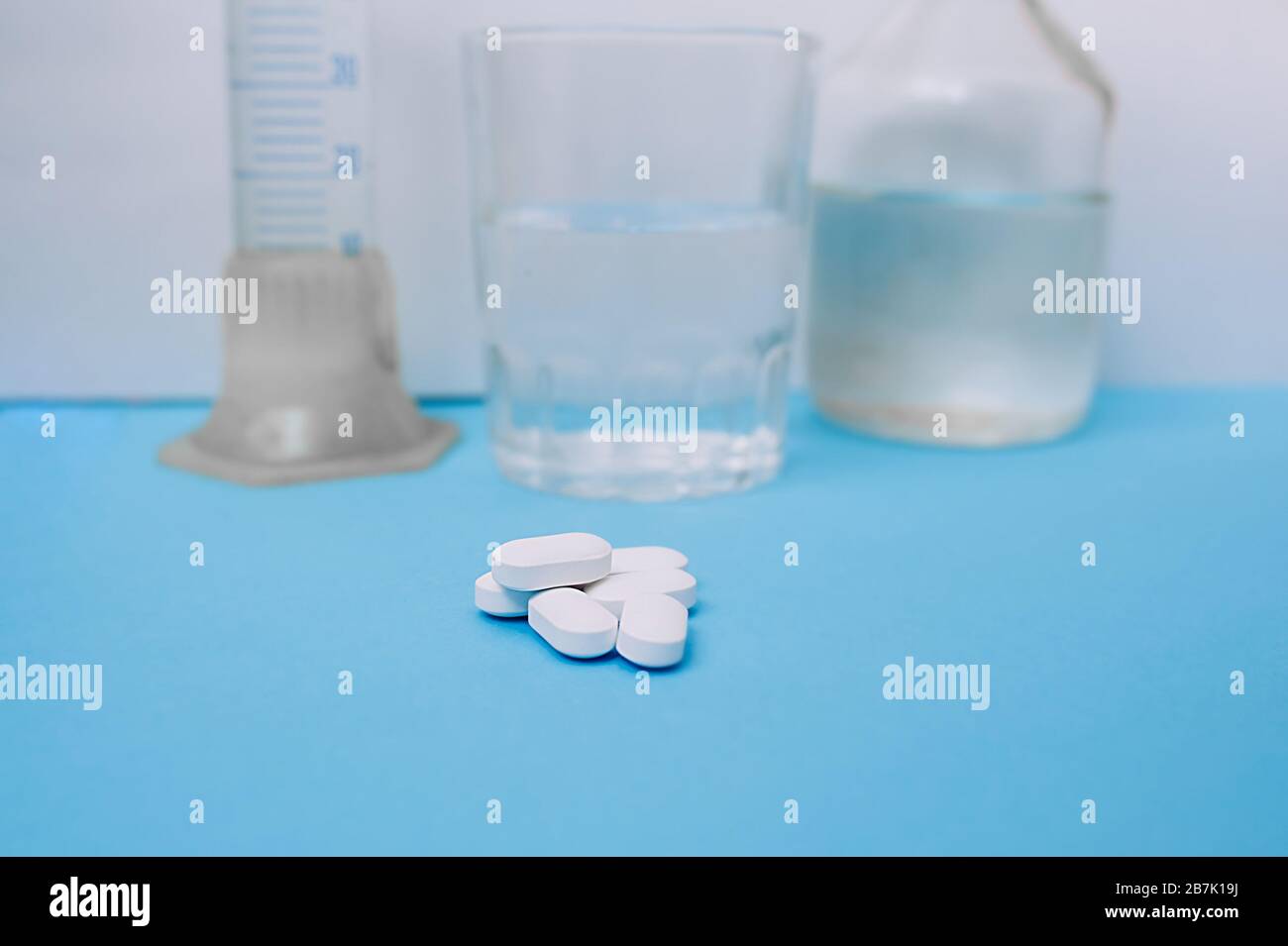 A handful of large white capsules of tablets against the background of ...