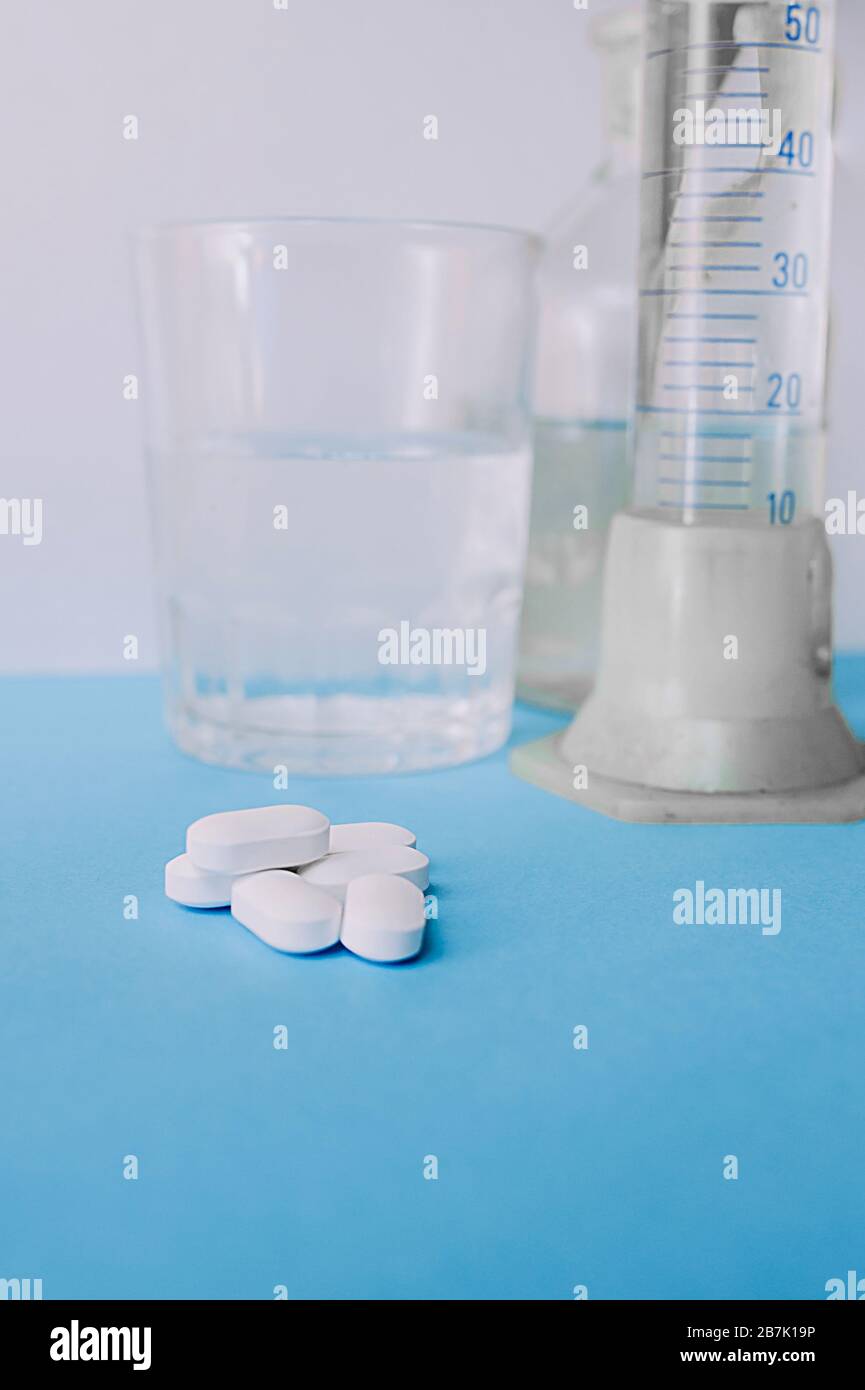 A handful of large white capsules of tablets against the background of ...