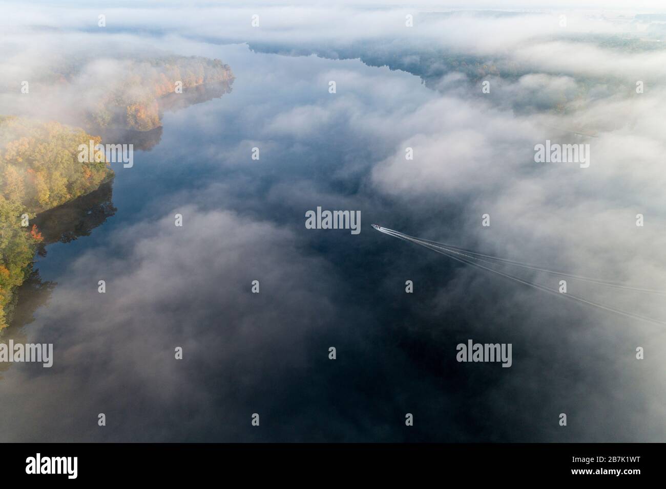 63895-17210 Boat on lake in fog in fall at Stephen A. Forbes State Park ...