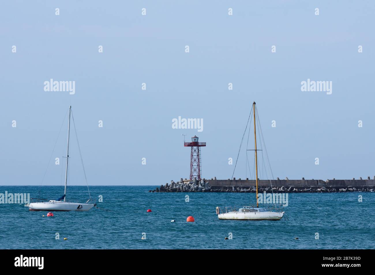 Sailing Boats And Harbor Lighthouse Beacon Stock Photo - Alamy
