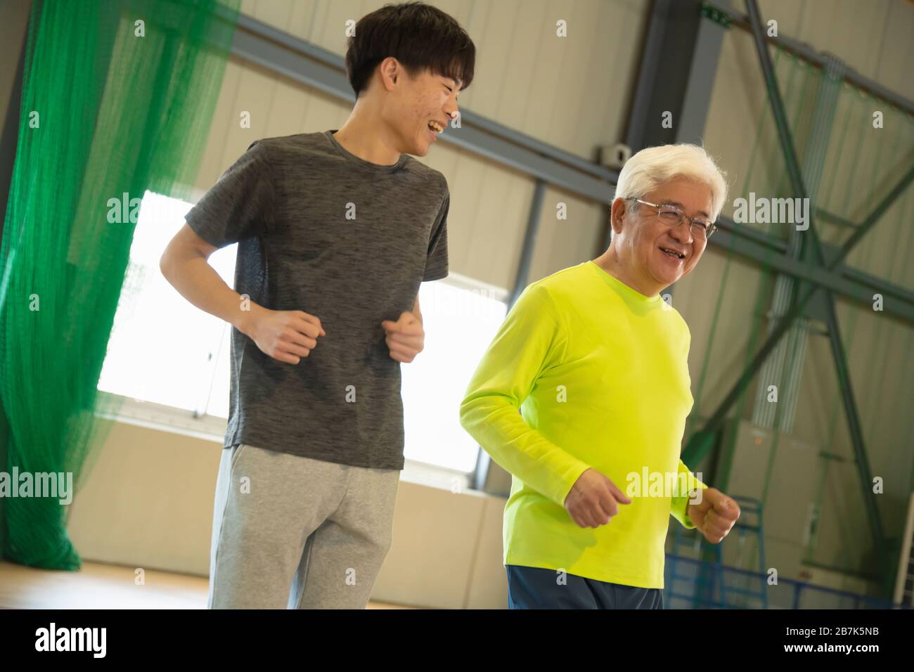 Senior and young people jogging with smile Stock Photo - Alamy