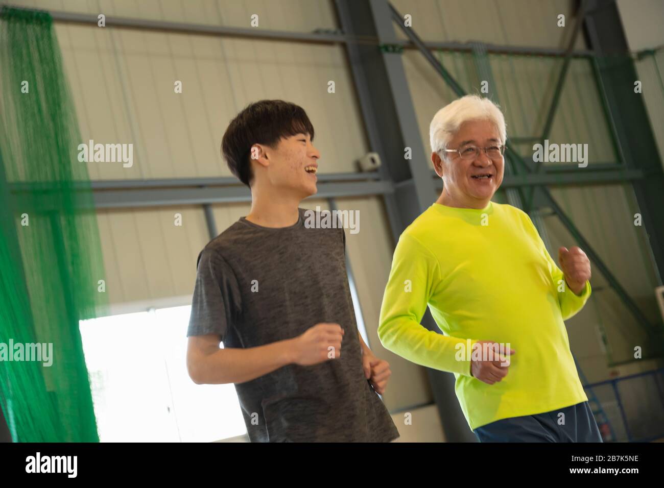 Senior and young people jogging with smile Stock Photo - Alamy