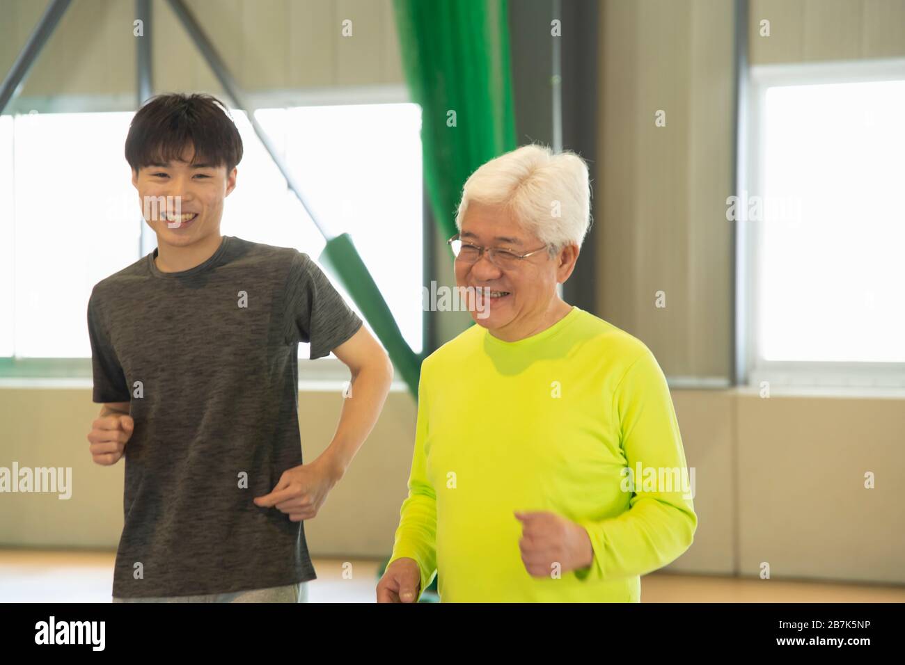 Senior and young people jogging with smile Stock Photo - Alamy