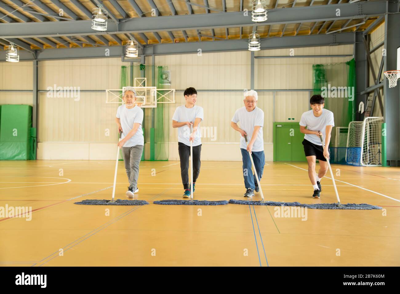 Senior and young people mopping in row Stock Photo - Alamy
