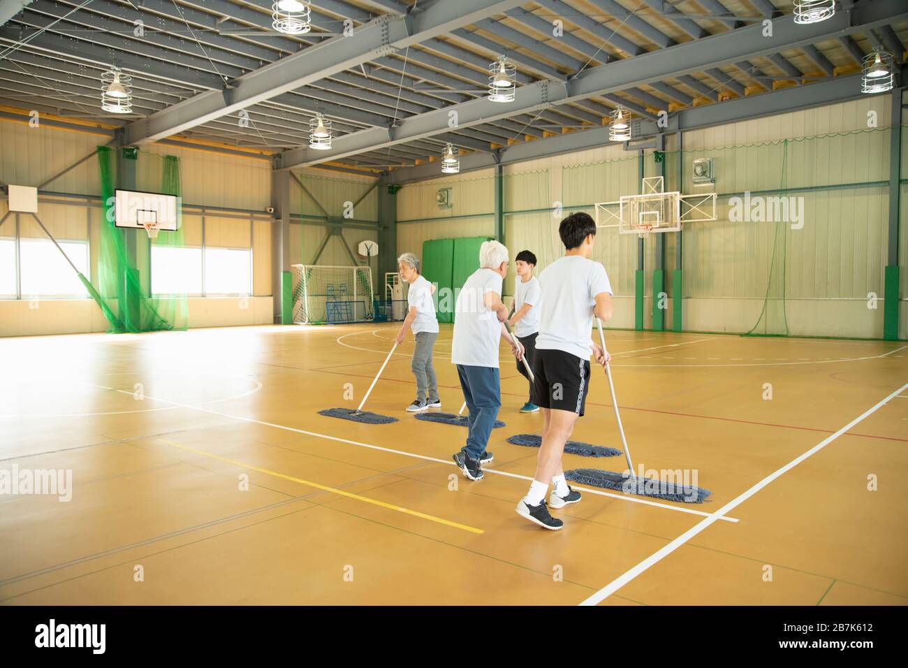 Senior and young people mopping in row Stock Photo - Alamy