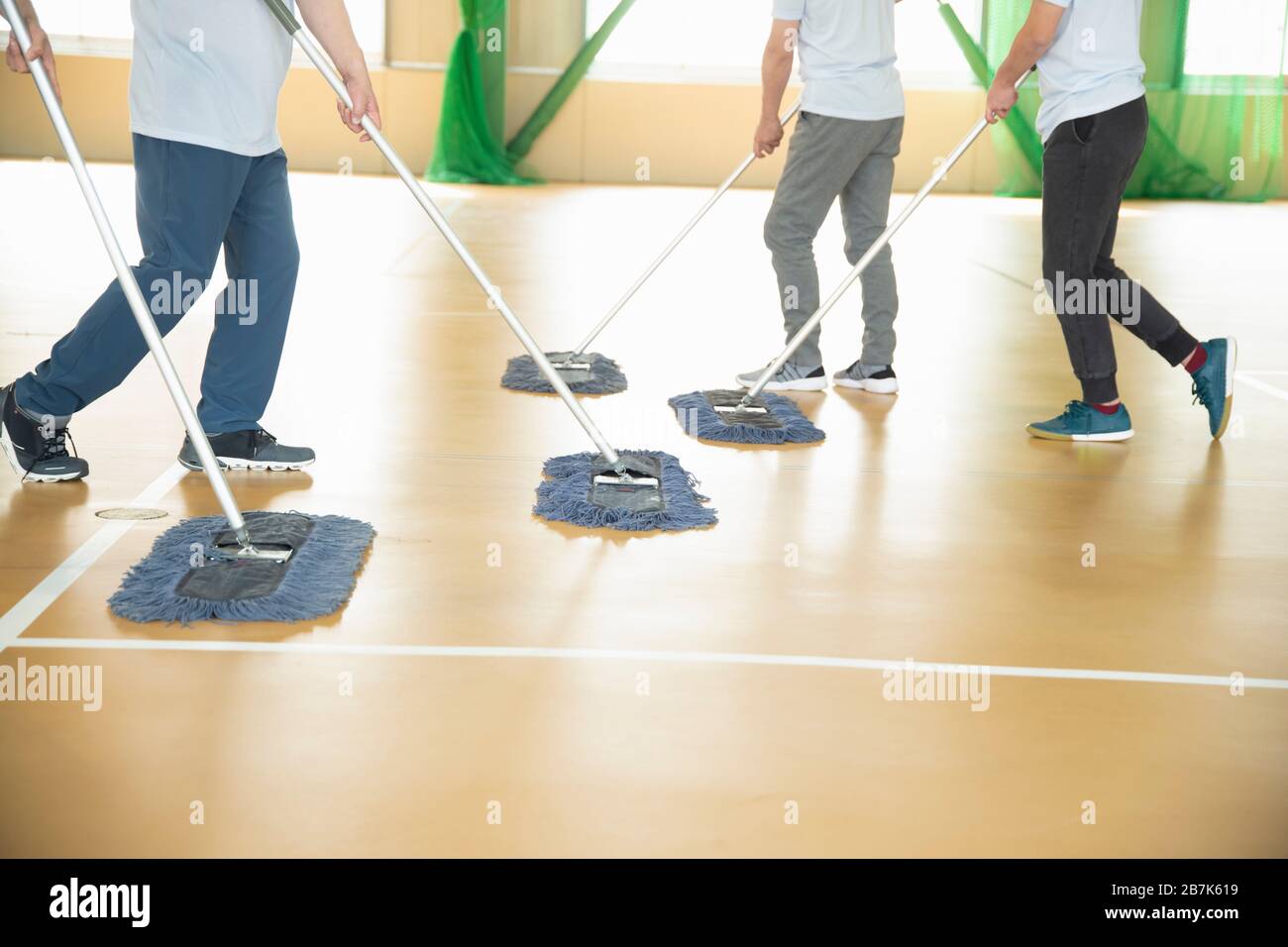 Senior and young people mopping in row Stock Photo - Alamy