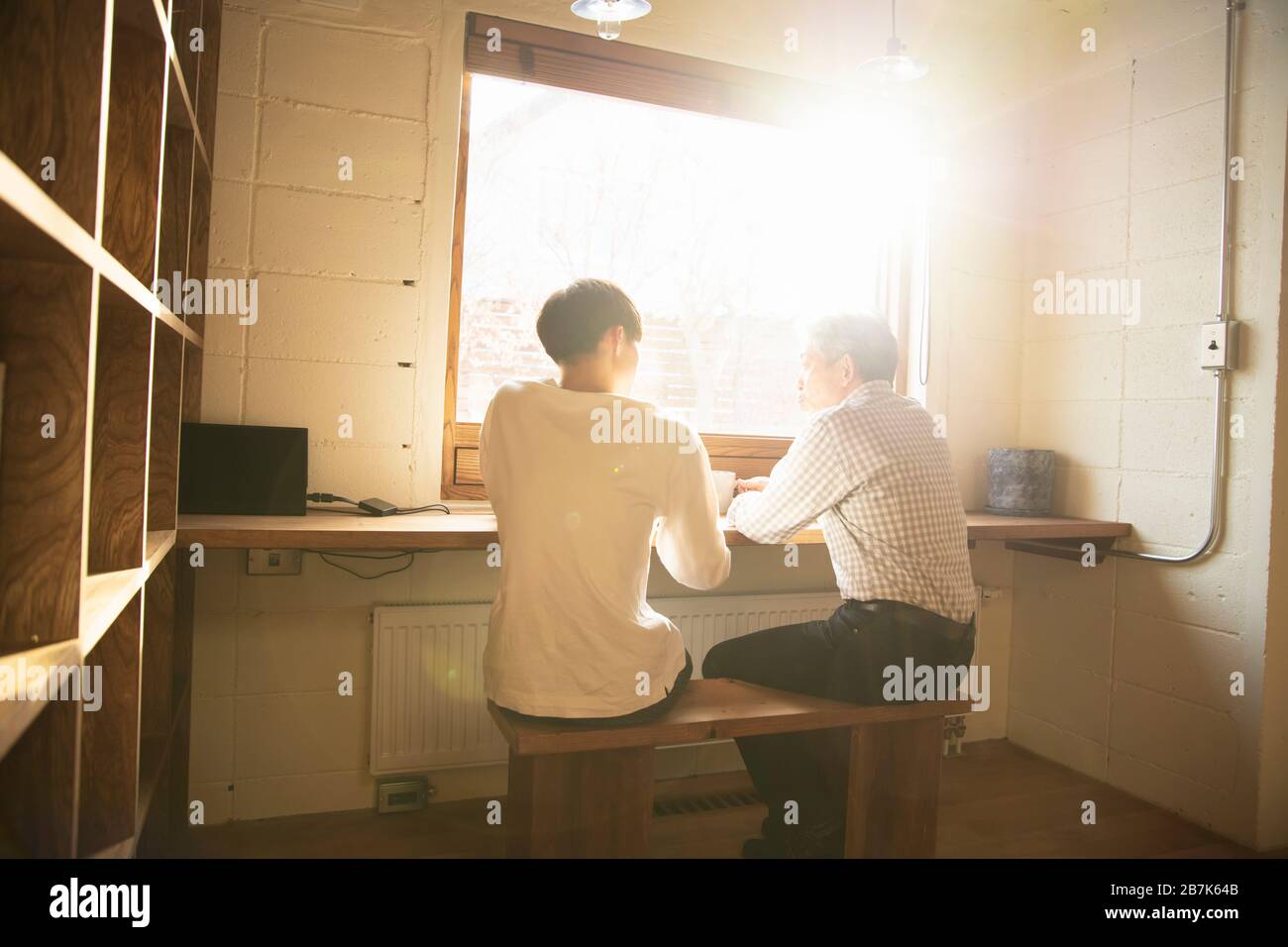 Senior and young people talking with smile by window Stock Photo - Alamy