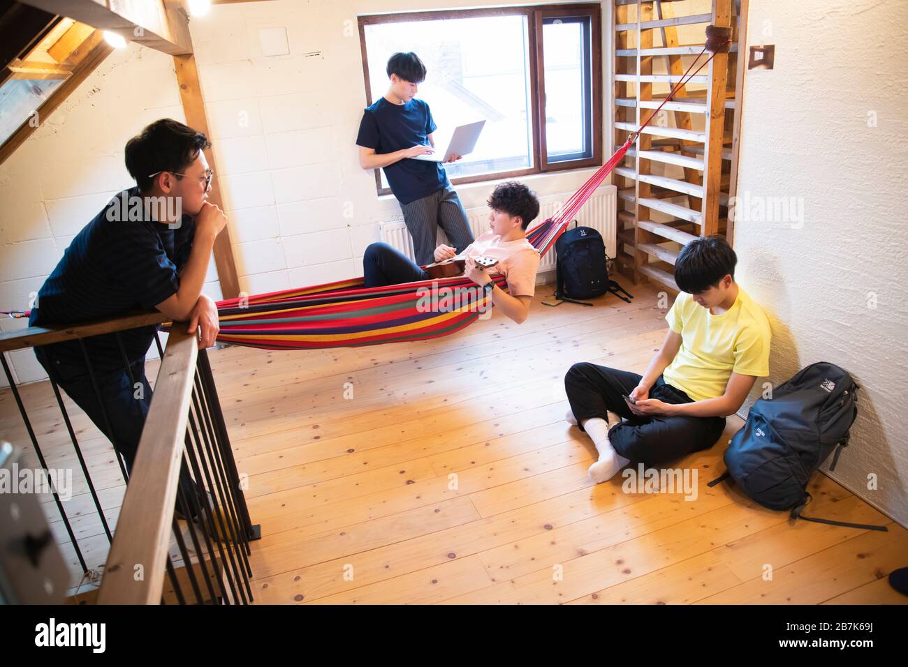 Four young people relaxing hi-res stock photography and images - Alamy