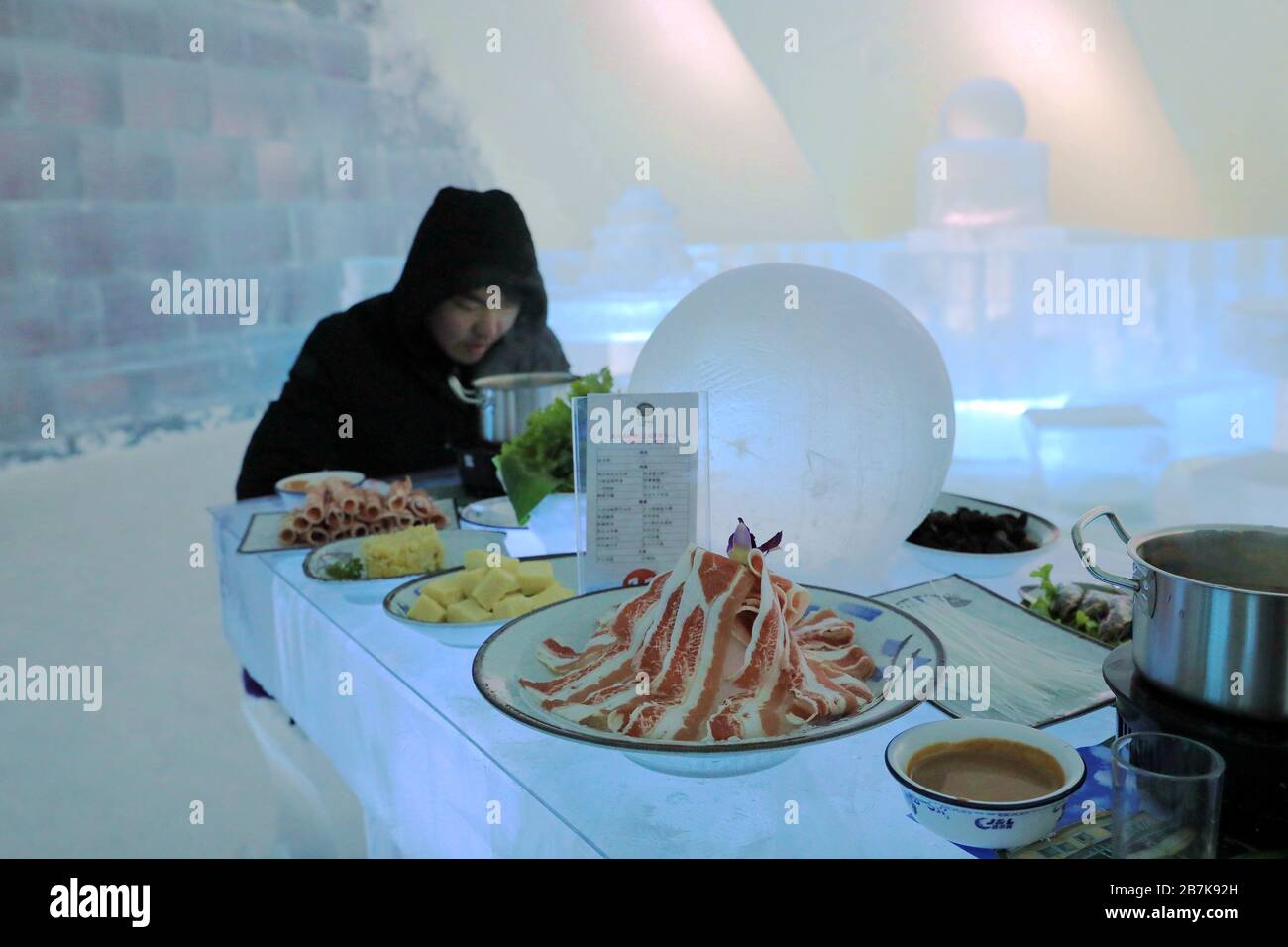 People eat hotpot in an ice-made hotpot restaurant in Harbin city ...