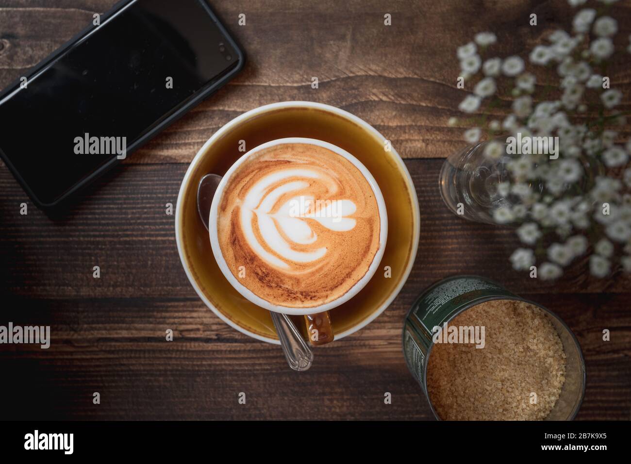 Top down image of a Latte and mobile phone showing the coffee culture ...