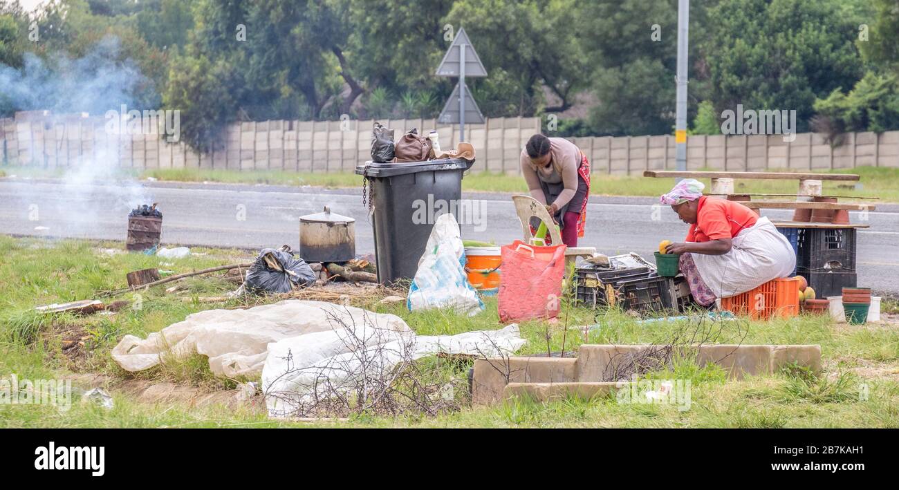 Alberton, South Africa - two black African women operate a makeshift ...