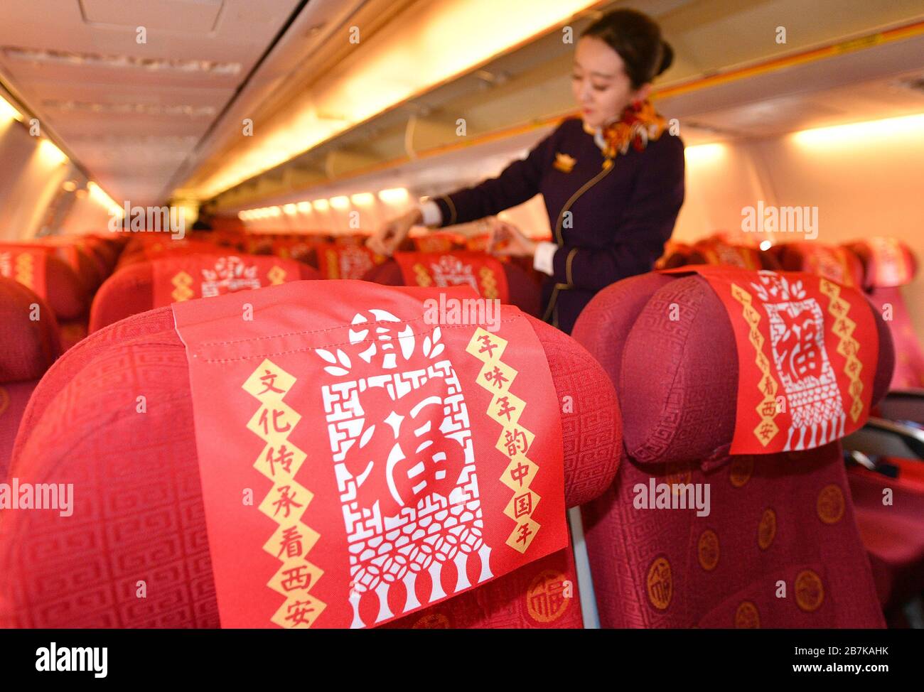 An airline stewardess prepares decorations at a Spring Festival themed ...