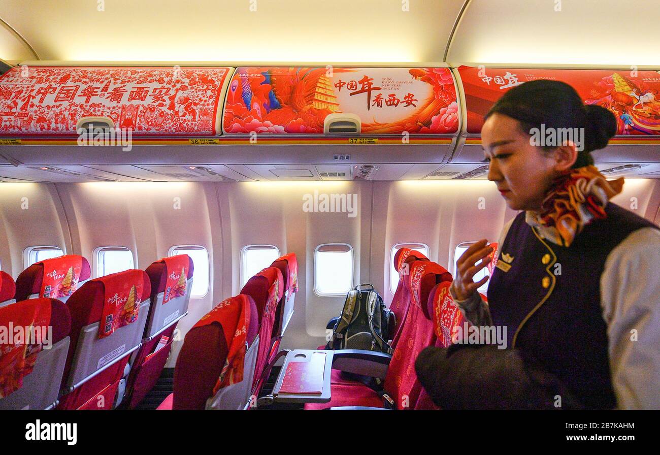 An airline stewardess prepares decorations at a Spring Festival themed ...