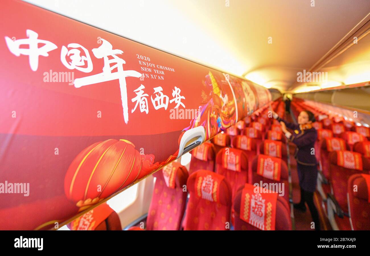 An airline stewardess prepares decorations at a Spring Festival themed ...