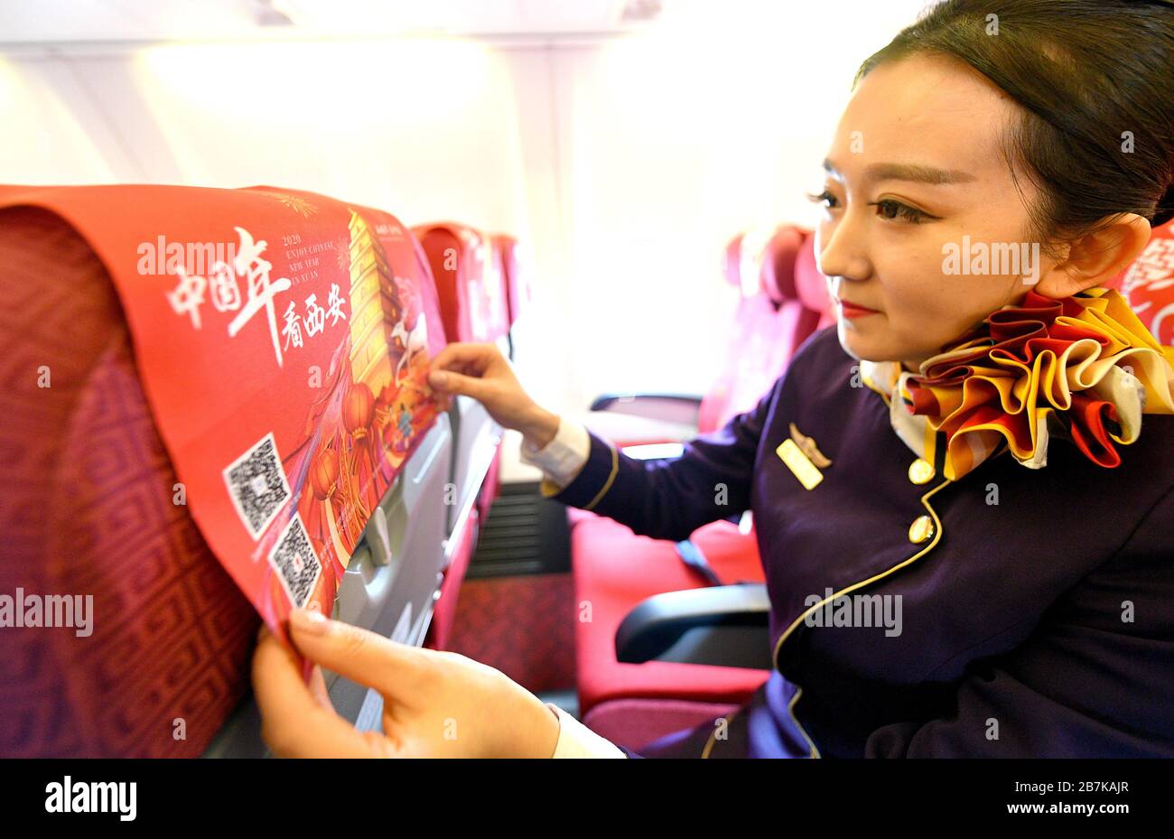 An airline stewardess prepares decorations at a Spring Festival themed ...