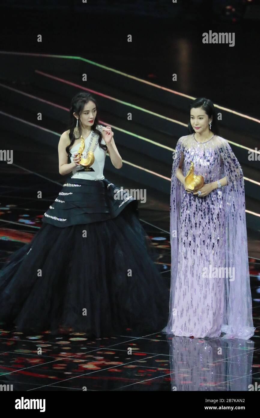 Chinese actress and singer Yang Mi, left, holds an award at the Weibo ...