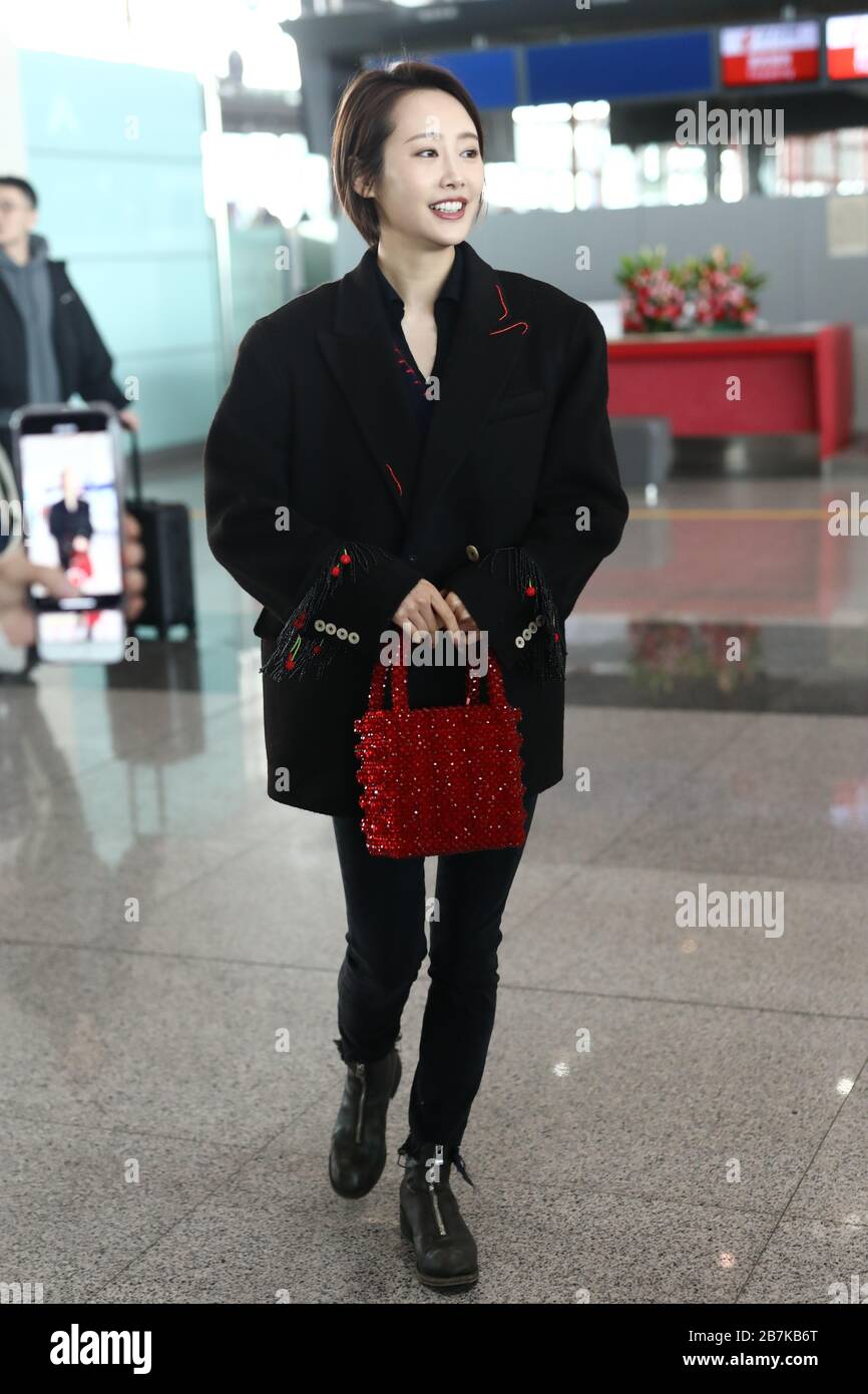Chinese actress Li Chun arrives at a Beijing airport before departure ...
