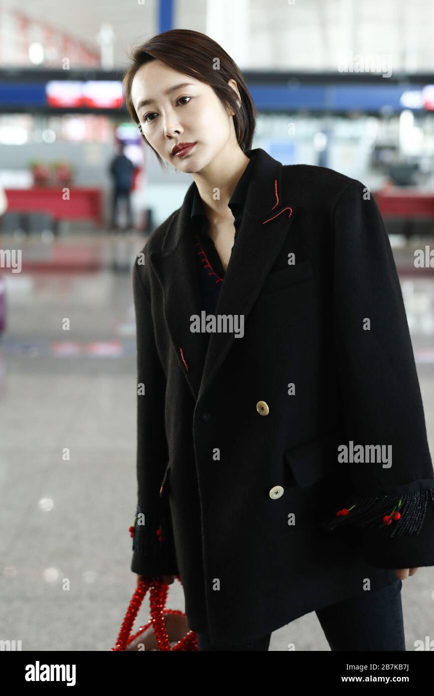 Chinese actress Li Chun arrives at a Beijing airport before departure ...