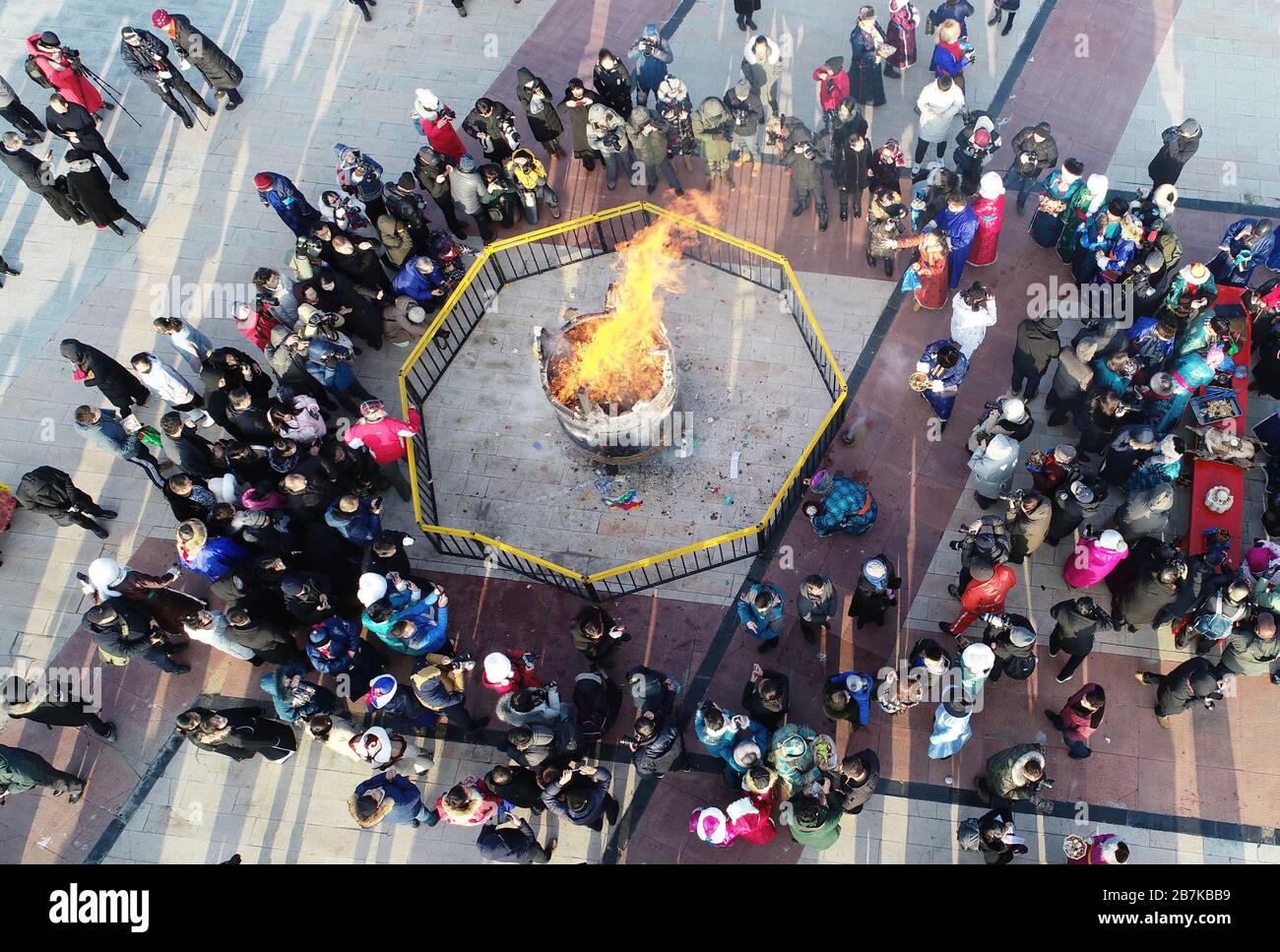 An aerial view of crowd surrounding a bonfire at a ceremony to ...