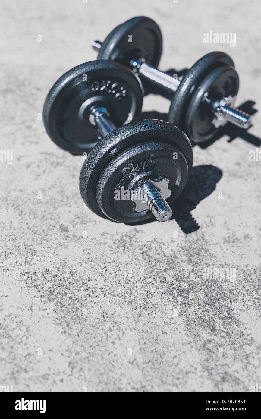keeping fit and exercising outdoor or at home, set of heavy dumbbells ...
