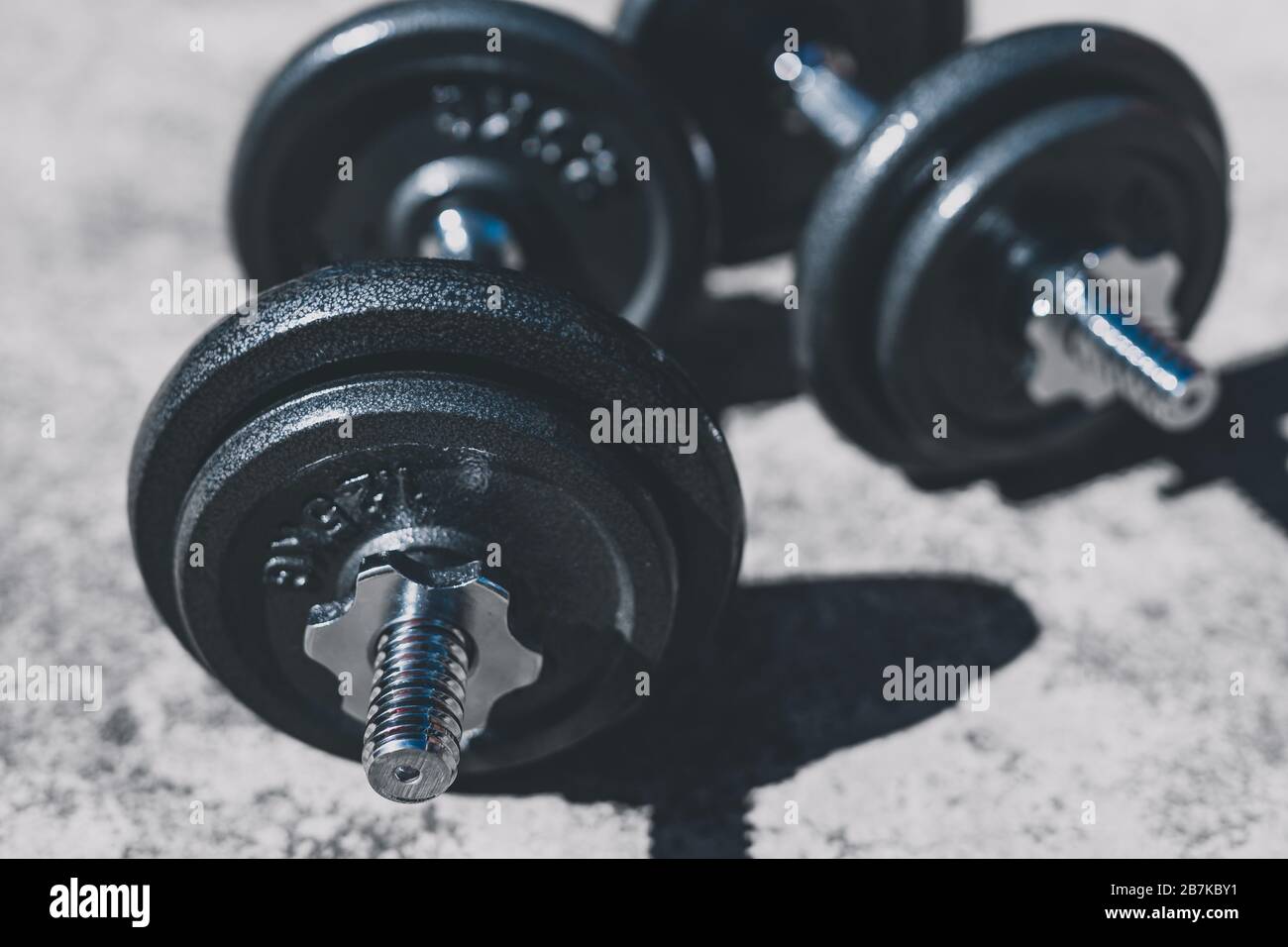 keeping fit and exercising outdoor or at home, set of heavy dumbbells ...