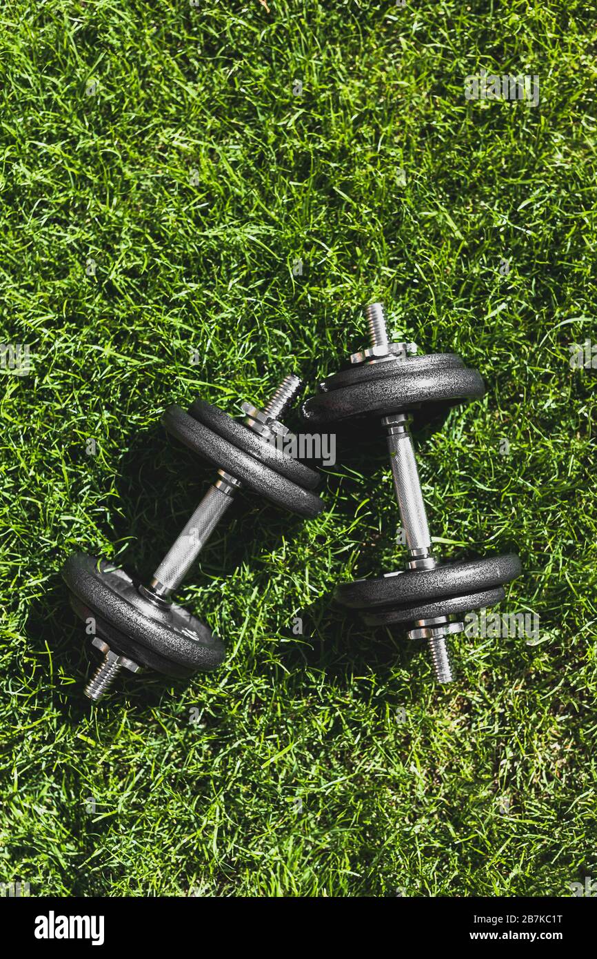 keeping fit and exercising outdoor or at home, set of heavy dumbbells ...