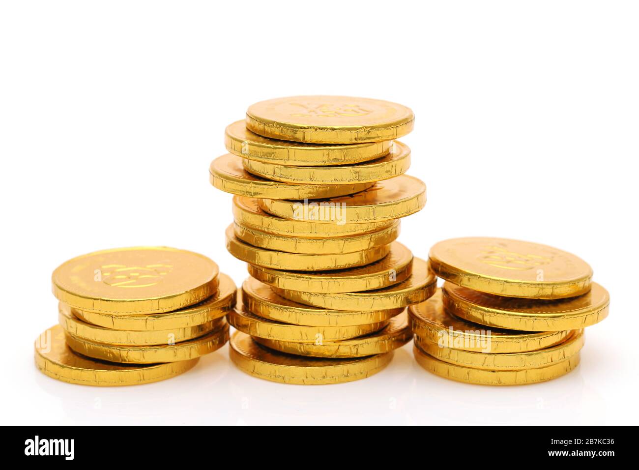 stacks of gold colored coins on white background Stock Photo - Alamy
