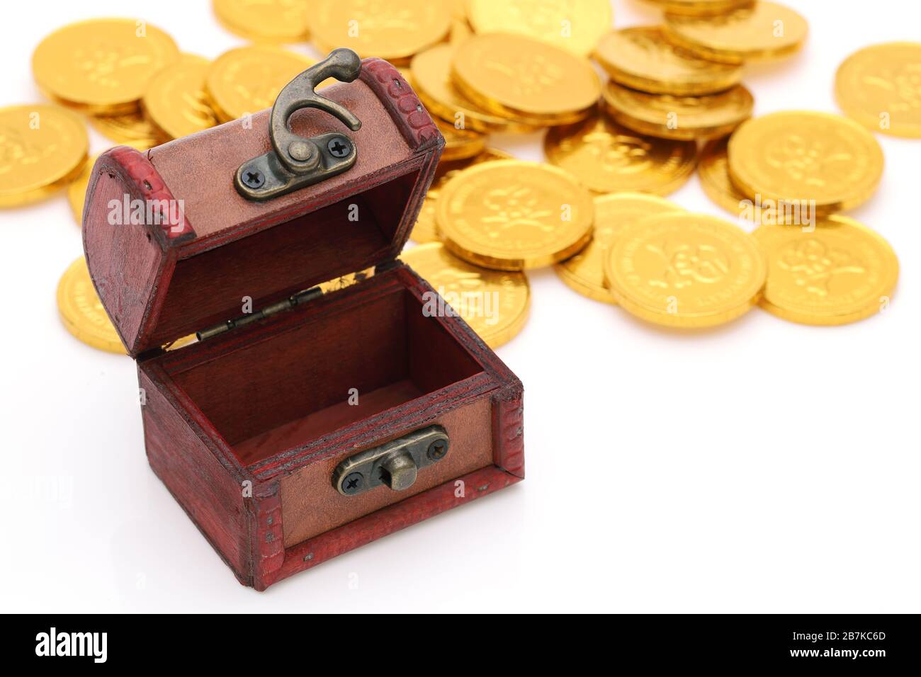 Opened treasure chest with gold colored coins on white background Stock ...