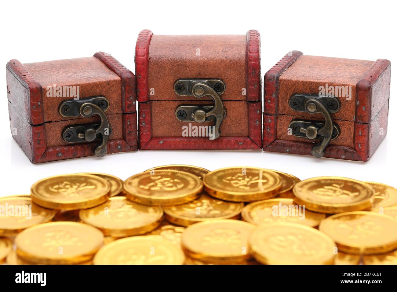 Closed treasure chest with gold colored coins on white background Stock ...
