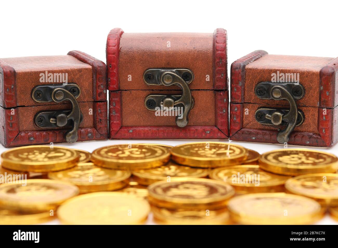 Closed treasure chest with gold colored coins on white background Stock ...