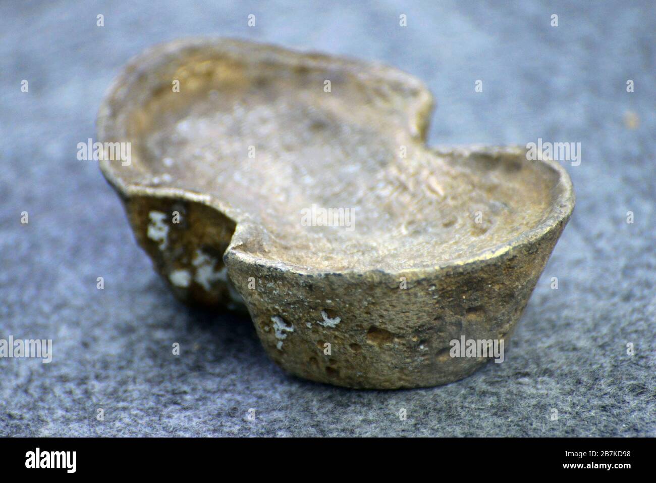 An ancient Chinese silver ingot or sycee of Ming Dynasty is on display ...