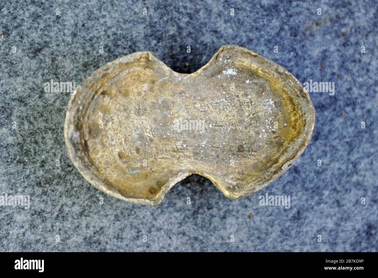 An ancient Chinese silver ingot or sycee of Ming Dynasty is on display ...