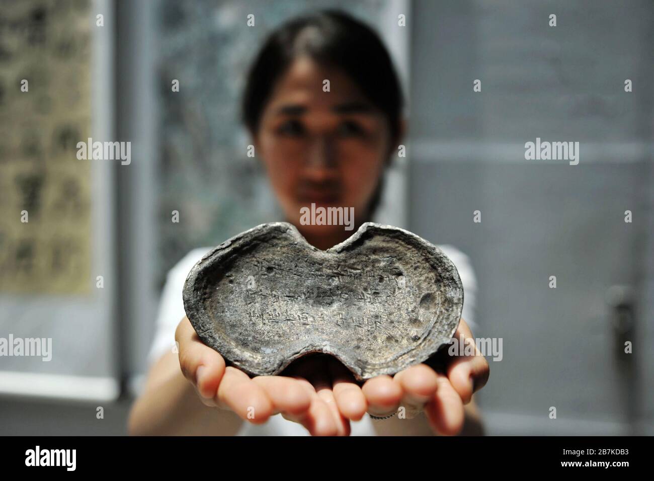 An ancient Chinese silver ingot or sycee of Ming Dynasty is on display ...