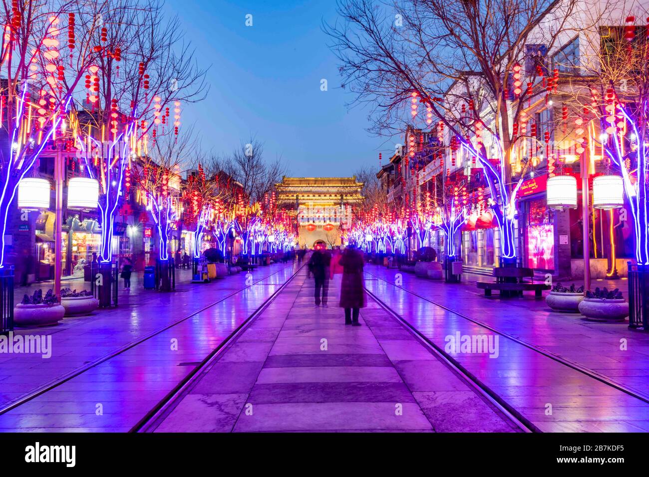 Pedestrians walk in Qianmen Walking Street where all lights turn on to ...
