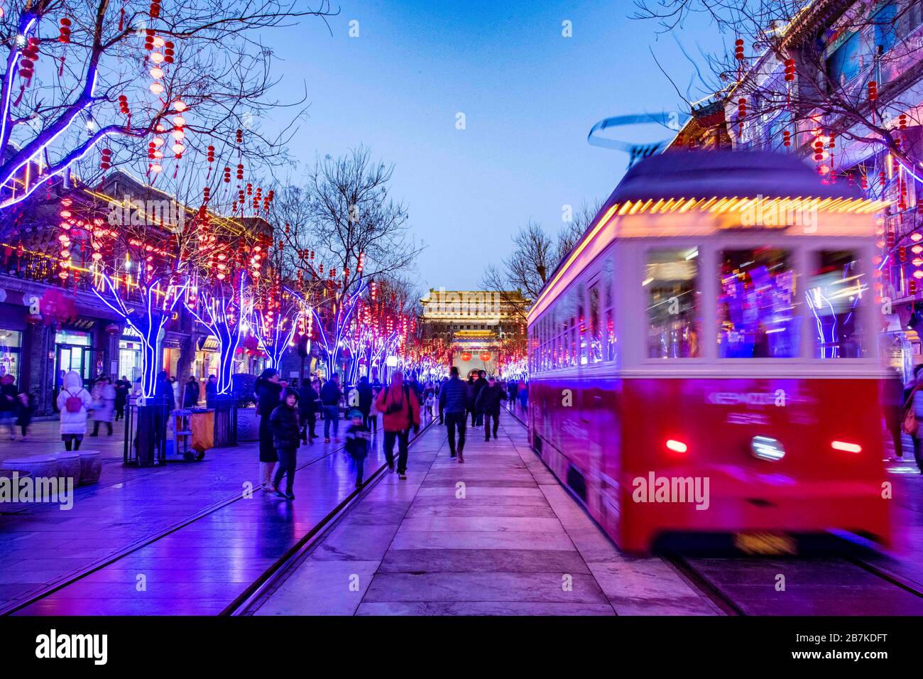 Pedestrians walk in Qianmen Walking Street where all lights turn on to ...