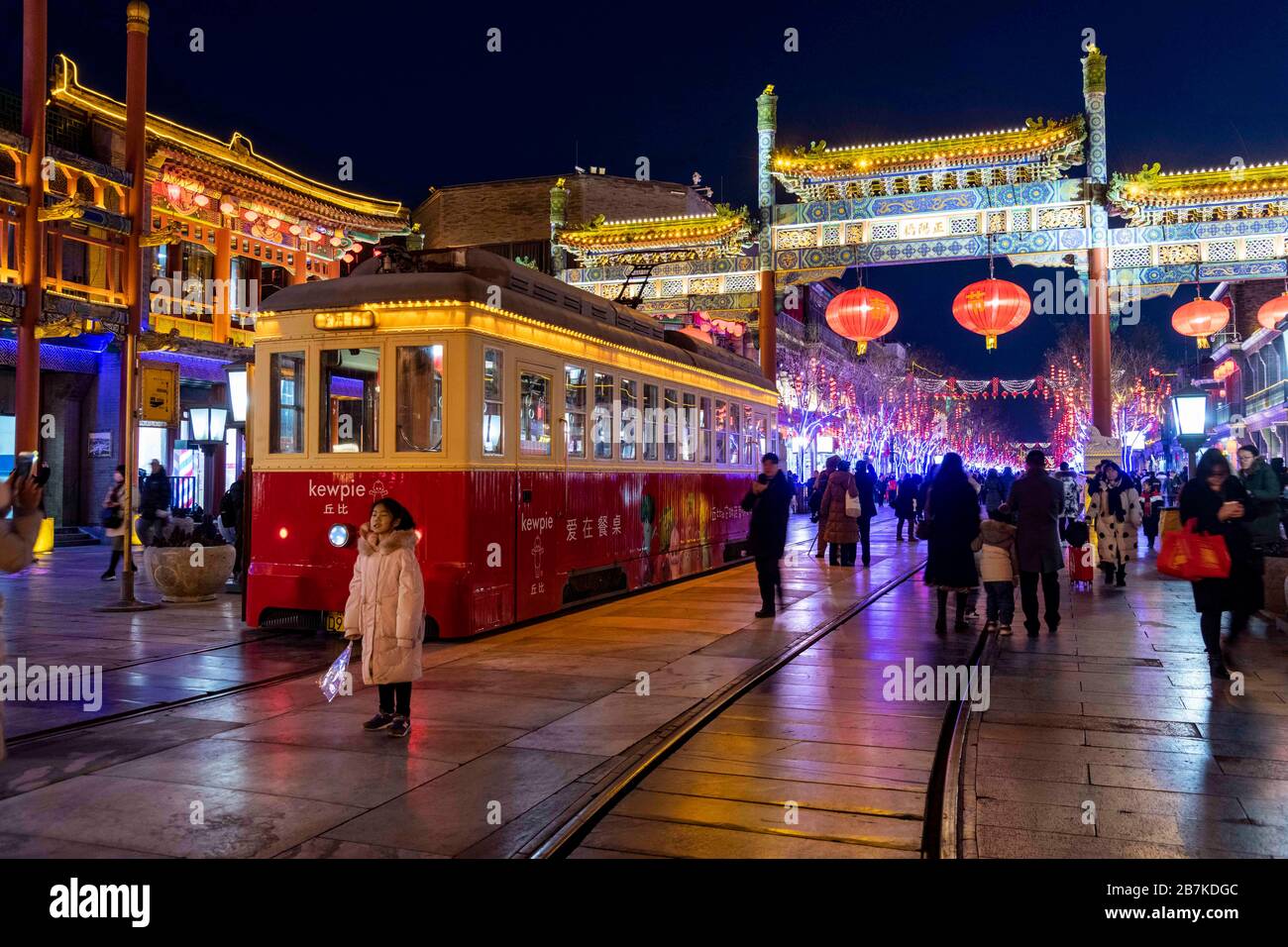 Pedestrians walk in Qianmen Walking Street where all lights turn on to ...