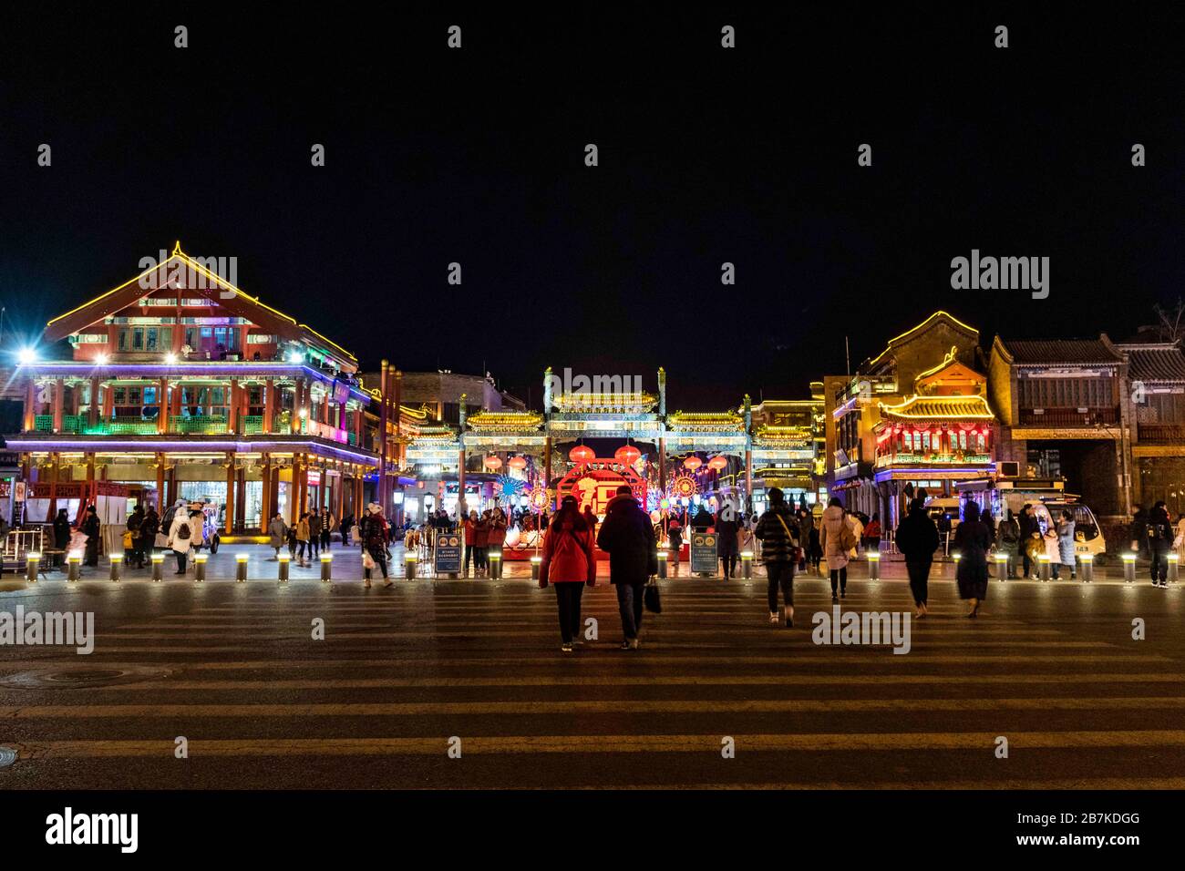 Pedestrians walk in Qianmen Walking Street where all lights turn on to ...