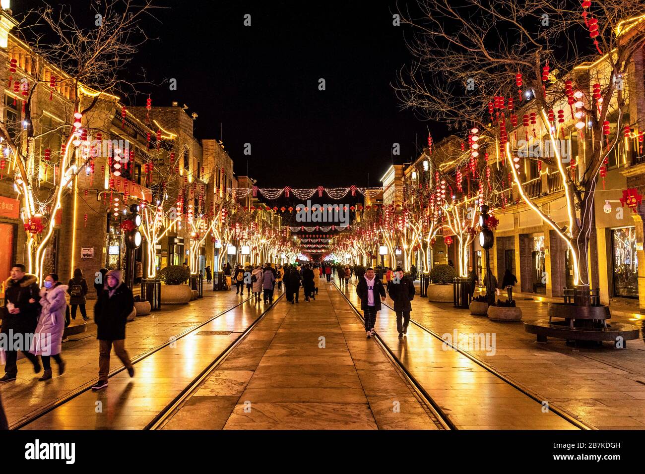 Pedestrians walk in Qianmen Walking Street where all lights turn on to ...