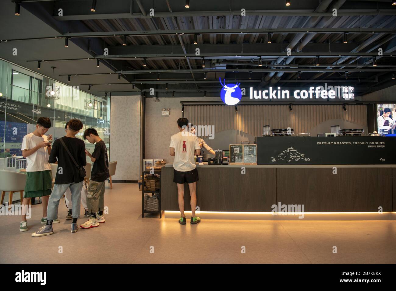 In this unlocated photo, people buy coffee at a Luckin Coffee, a chain ...