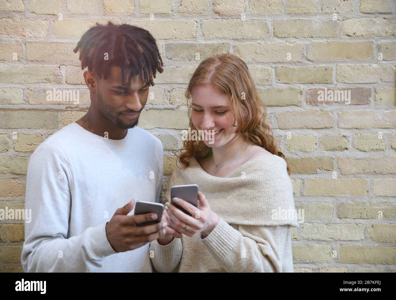 Millenials Laughing and Using Smartphones. Sharing Concept - Diversity ...