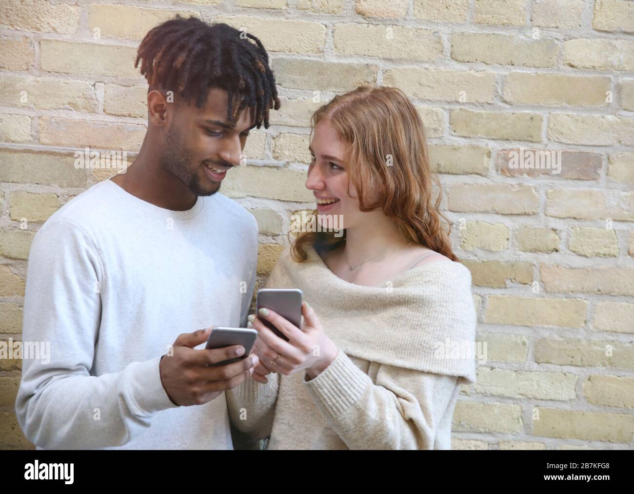 Millenials Laughing and Using Smartphones. Sharing Concept - Diversity ...