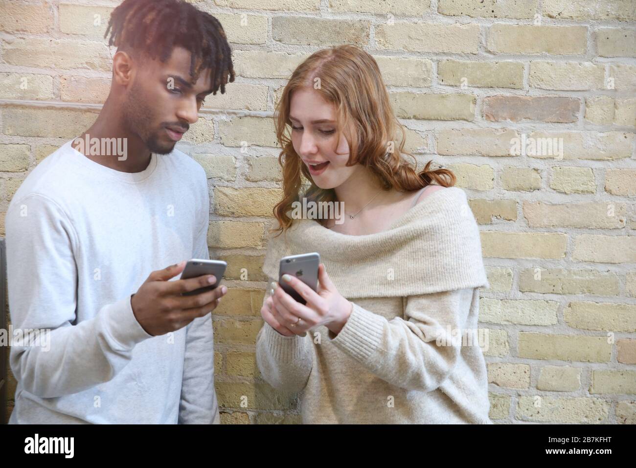 Millenials Laughing and Using Smartphones. Sharing Concept - Diversity ...