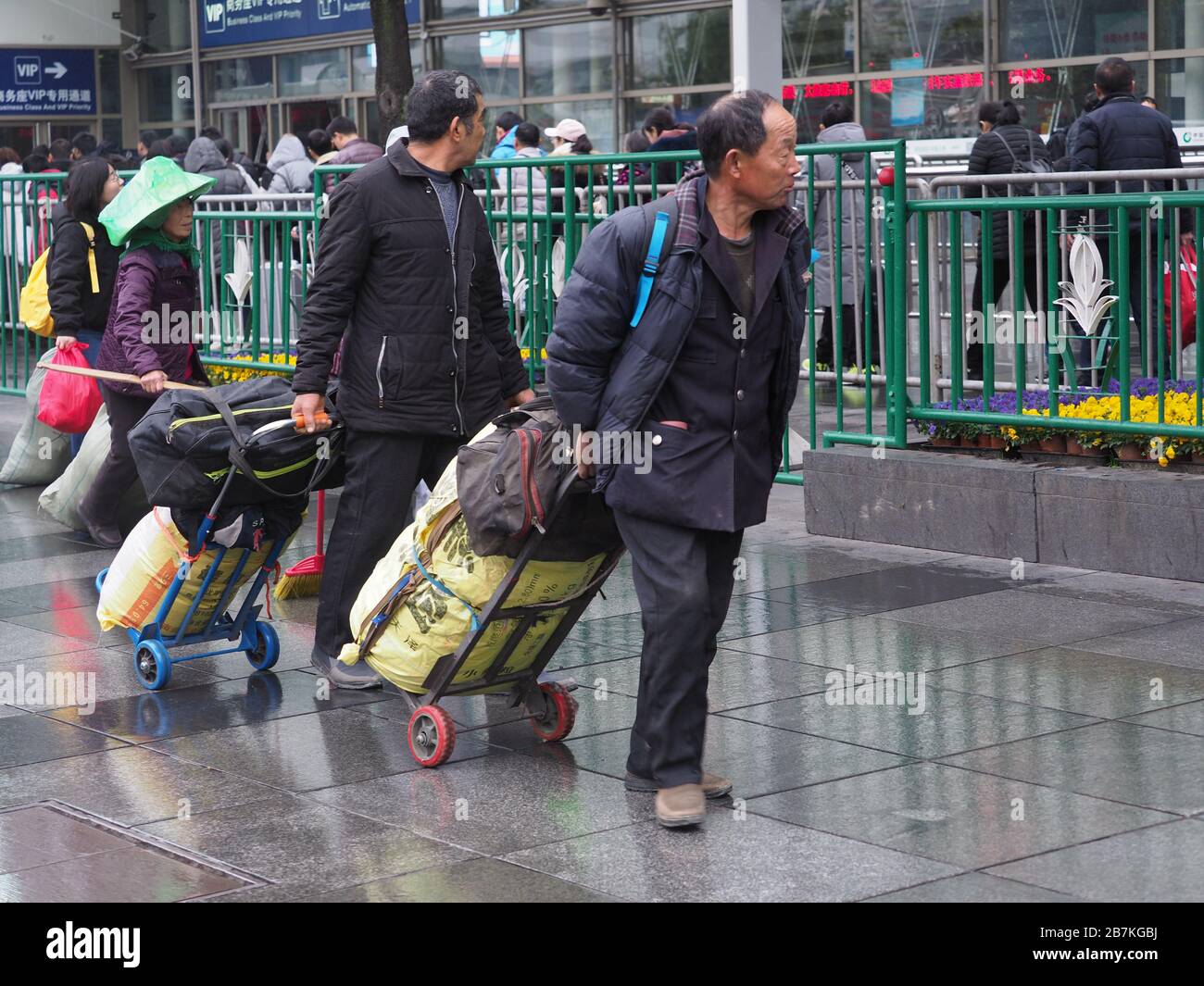--File--Migrant workers carry luggages at the Shanghai New Bus Terminal ...